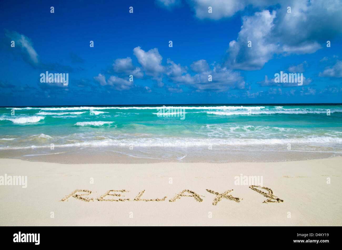 Word Relax on sand beach Stock Photo - Alamy