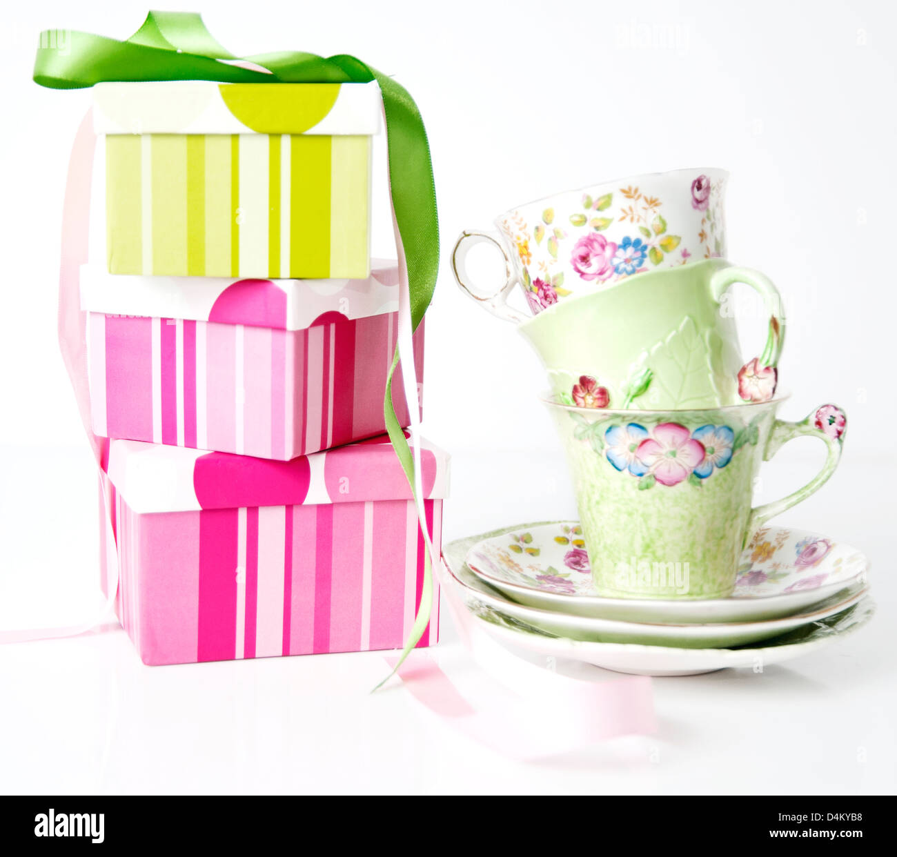 Colorful gift boxes stacked up beside stacked tea cups Stock Photo - Alamy