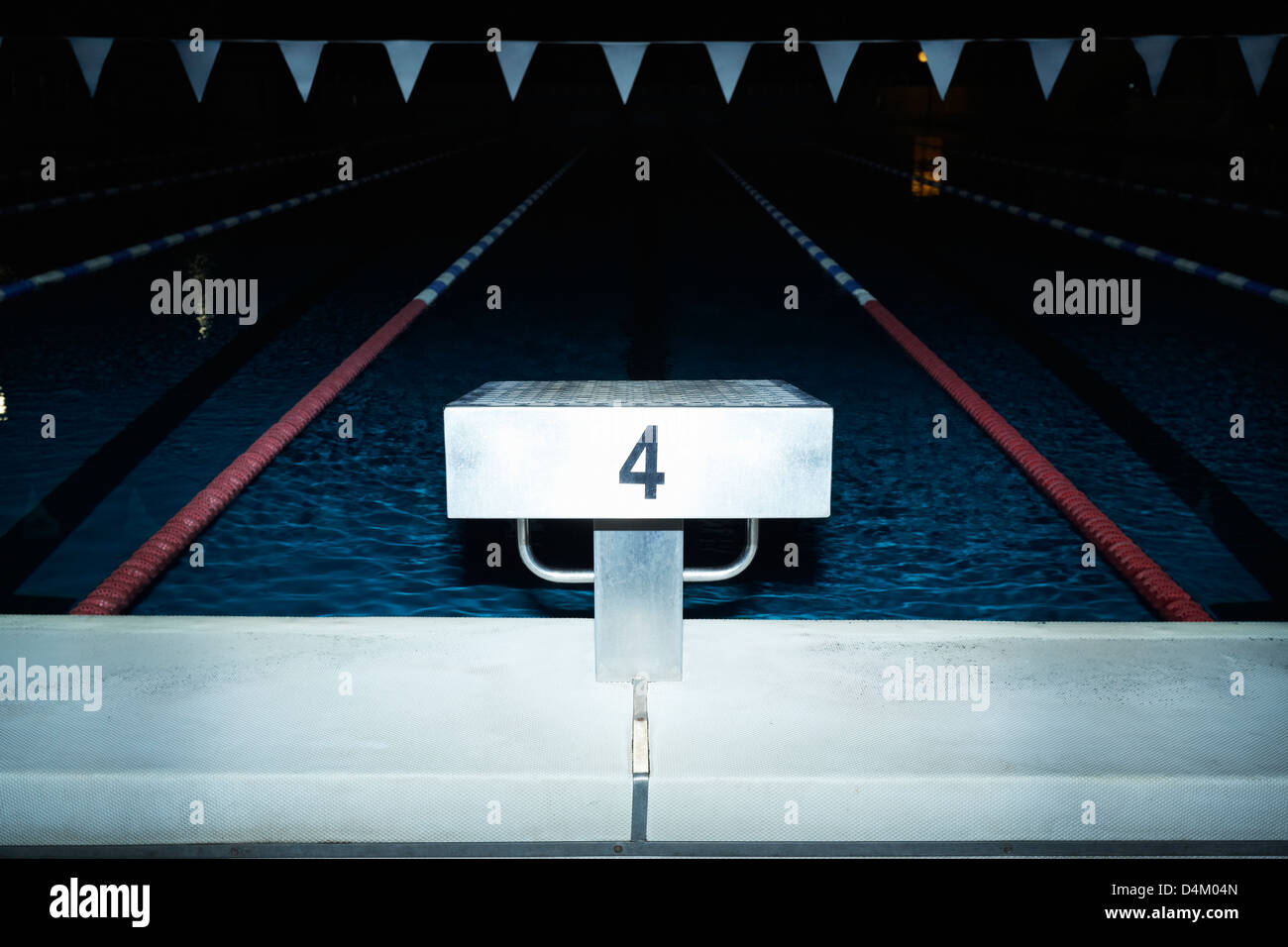 Springboard over lap pool at night Stock Photo - Alamy