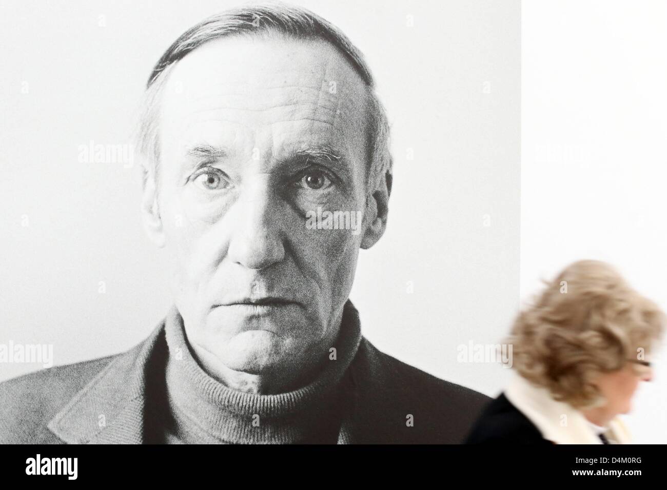 A visitor walks past a portrait of William S. Burroughs after a press ...