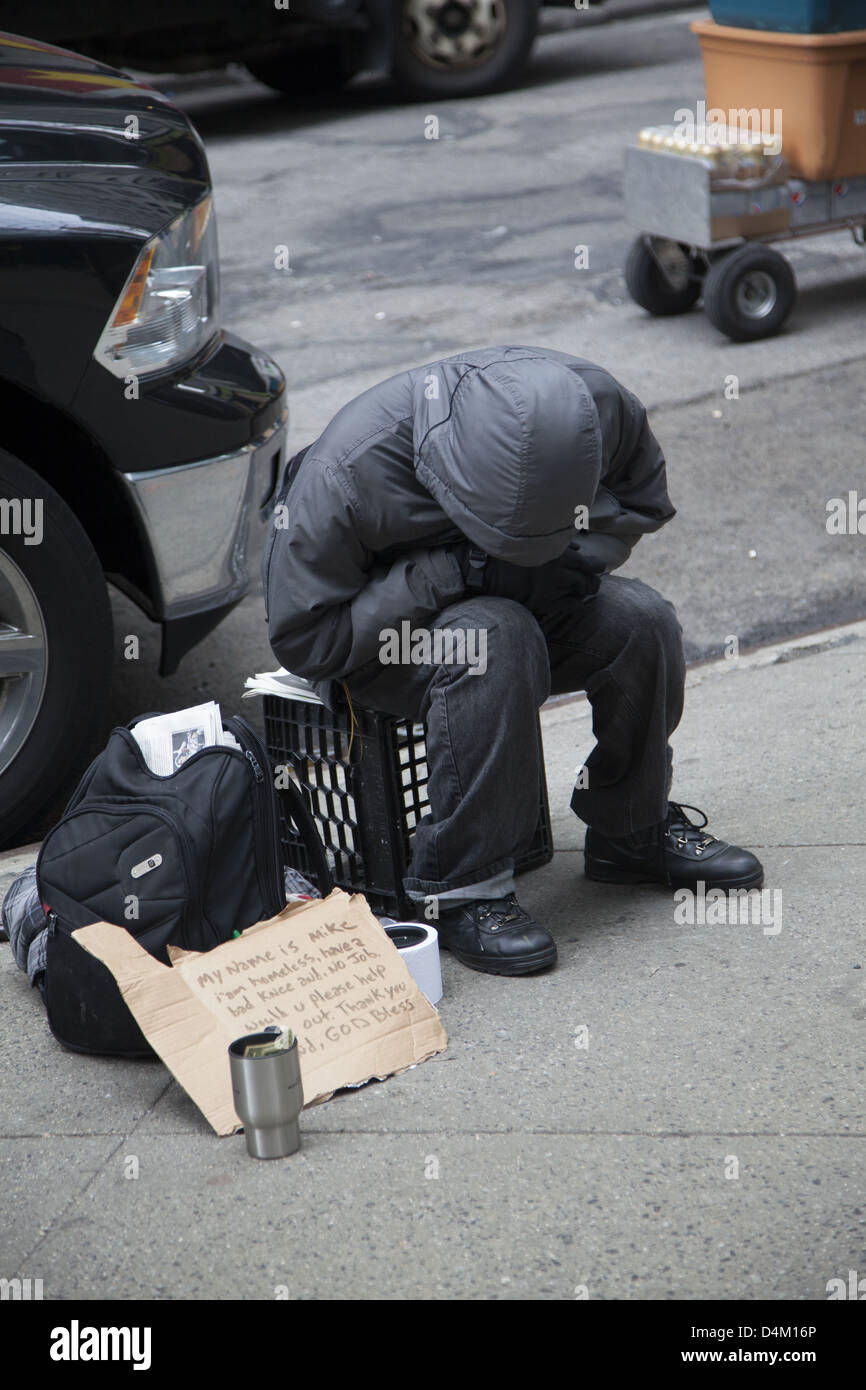 Homeless man begging on the street along 5th Avenue in New York City ...