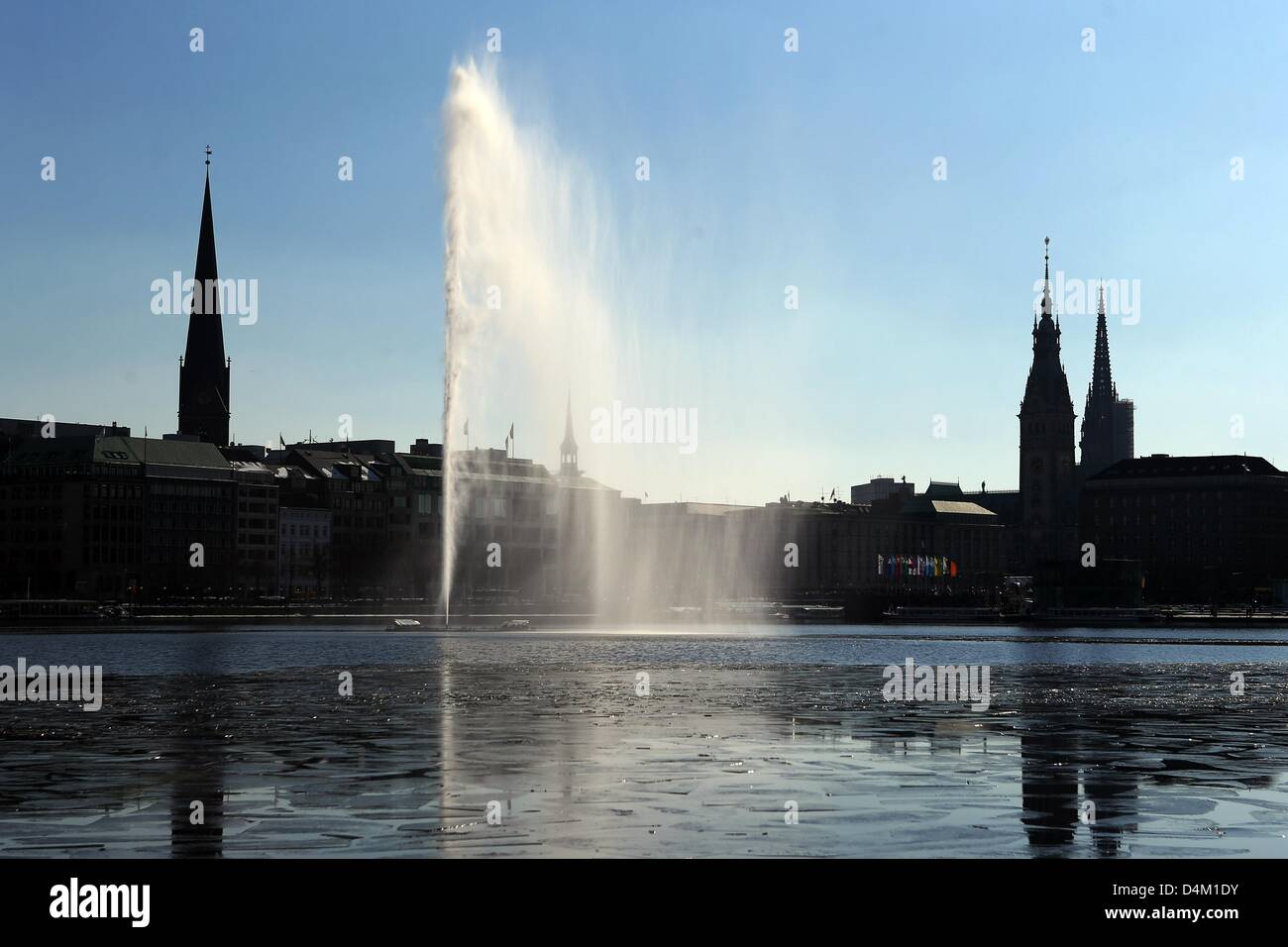 View of the Alster fountain on the inner Alster lake in front of the ...