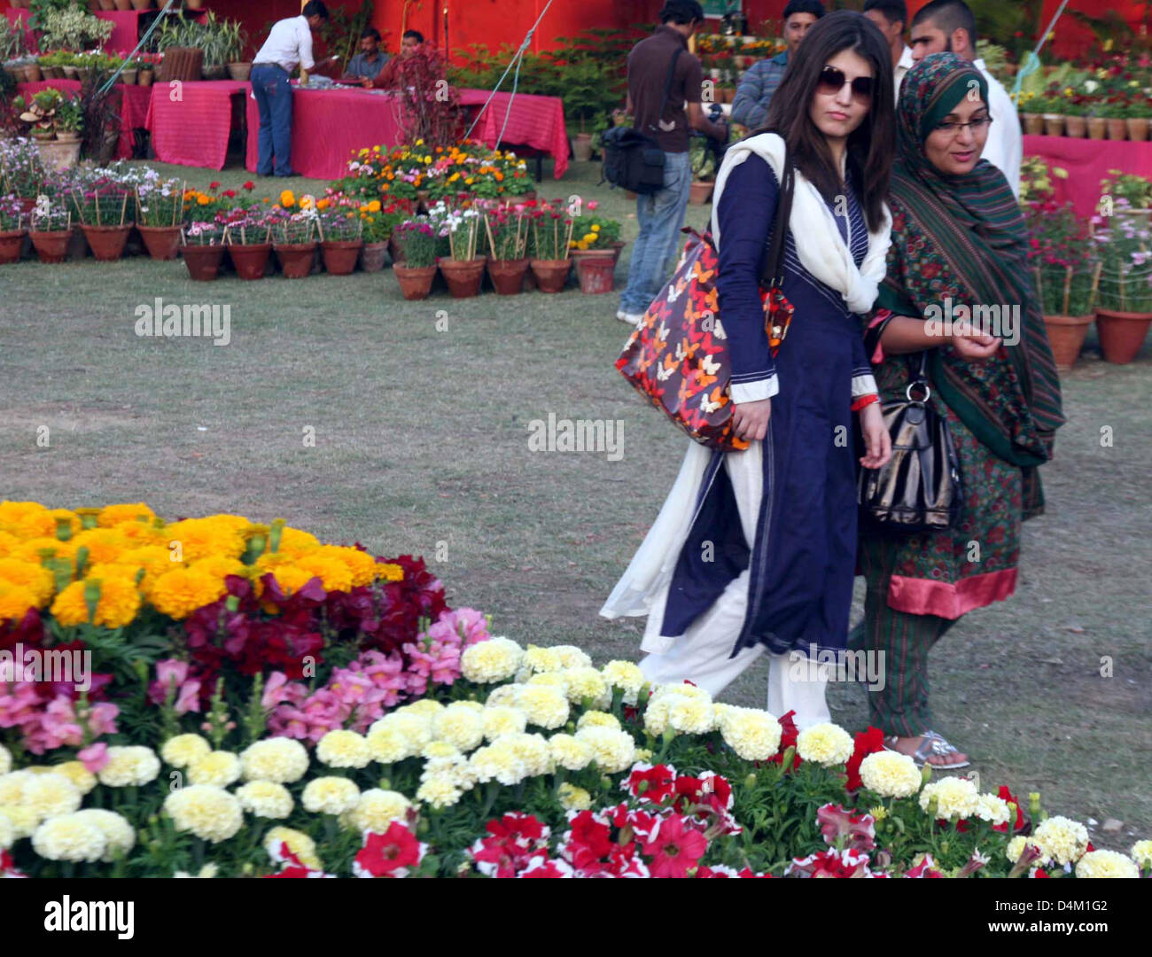 Visitors take keen interest in flowers during flower show organized by ...