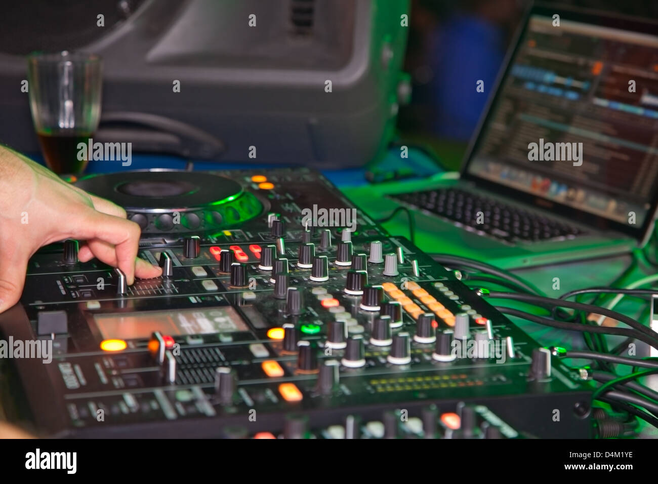 DJ behind the decks in night club Stock Photo - Alamy