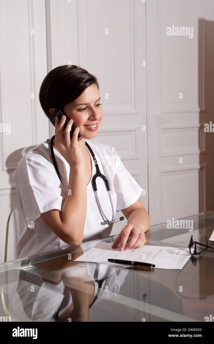 Doctor answering phone desk hi-res stock photography and images - Alamy