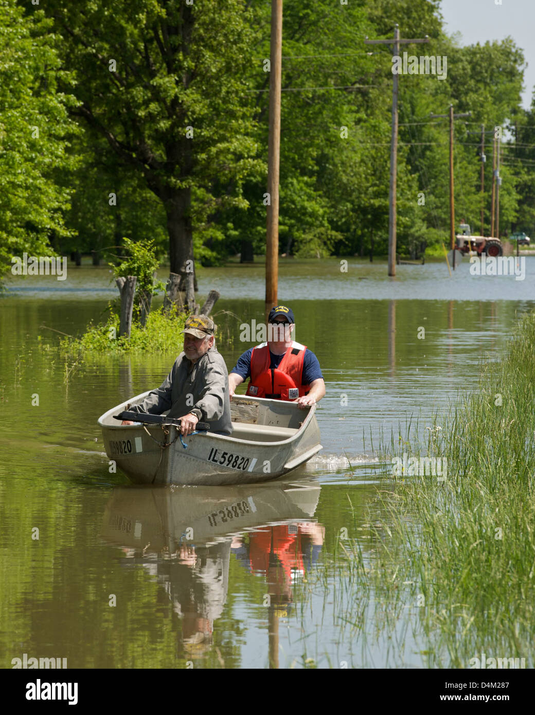 A Coast Guard reservist navigates through floodwaters during a disaster ...