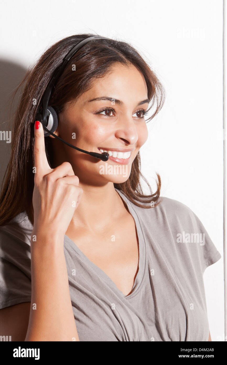Smiling woman wearing headset Stock Photo - Alamy