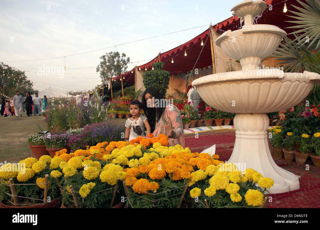 Visitors take keen interest in flowers during flower show organized by ...