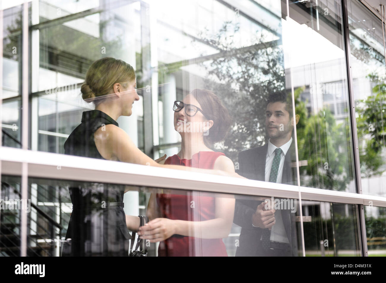 Business people talking by window Stock Photo - Alamy