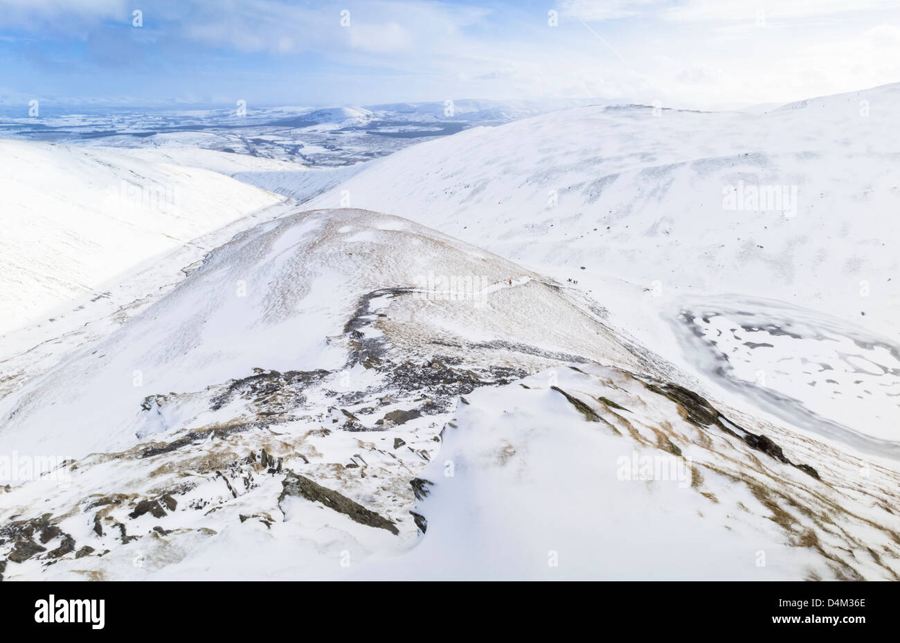 A hikers approaching Sharp Edge in the distance on route to the summit ...