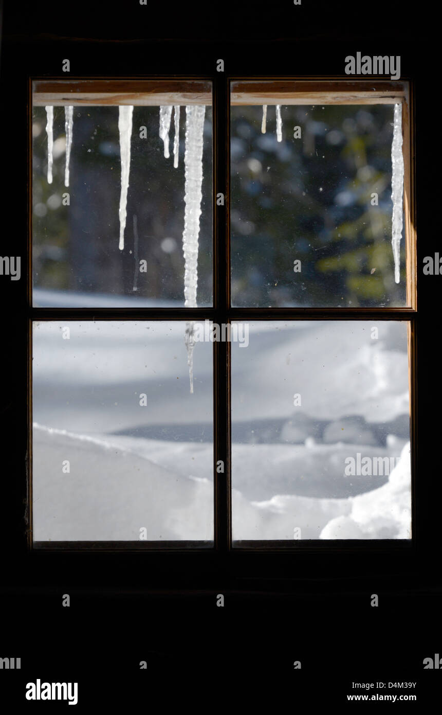 Icicles outside the window of an old cabin in Oregon's Wallowa ...