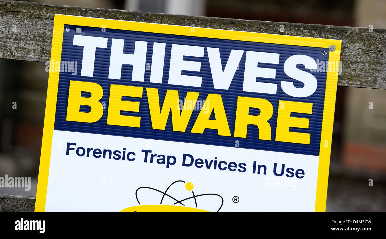 Thieves beware forensic trap devices in use sign Stock Photo - Alamy