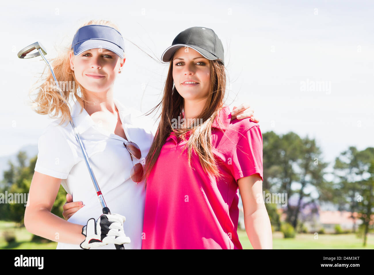 Women smiling together on golf course Stock Photo - Alamy