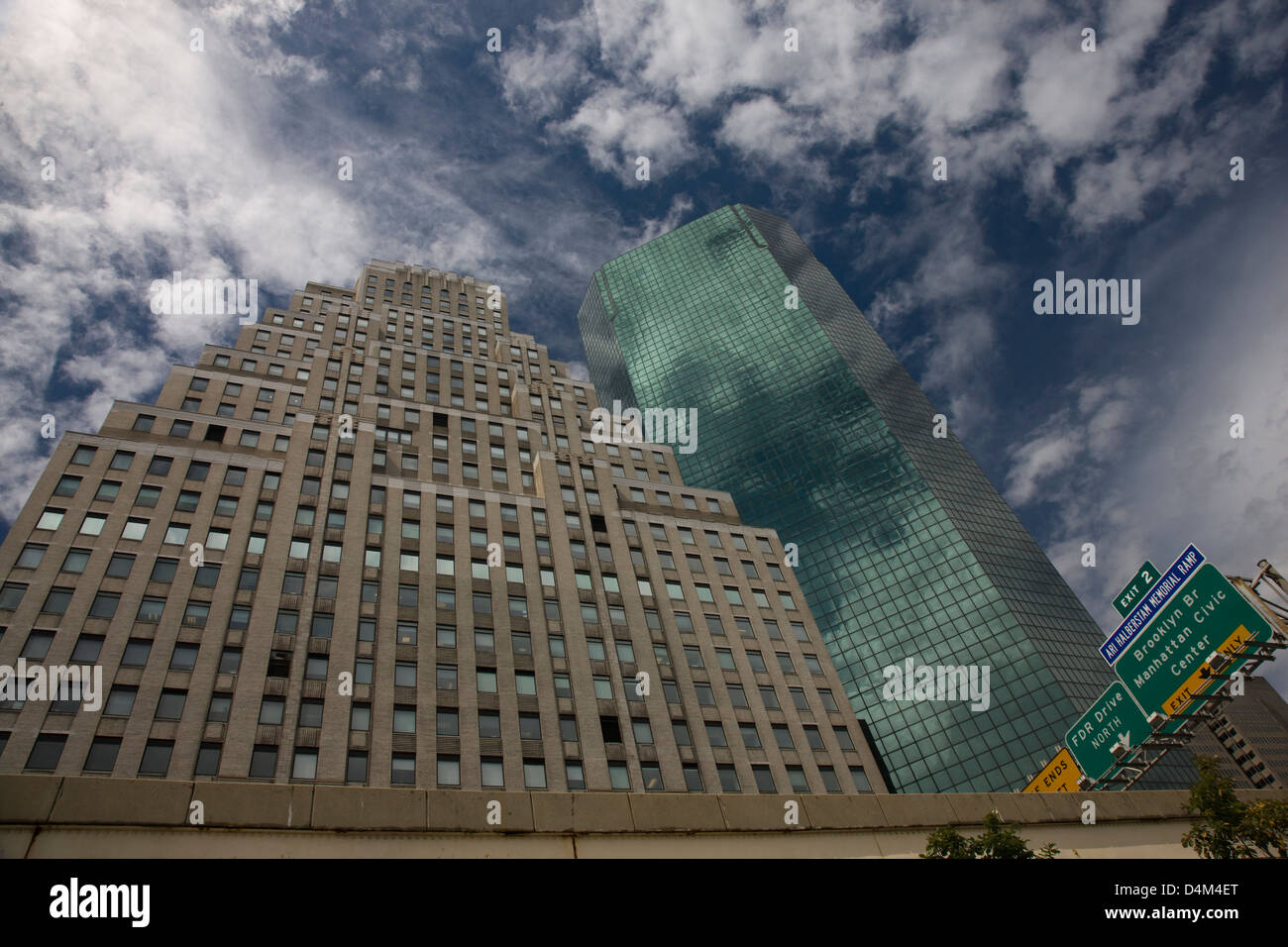 Tiered older style 1930s skyscraper next to modern glass skyscraper in ...