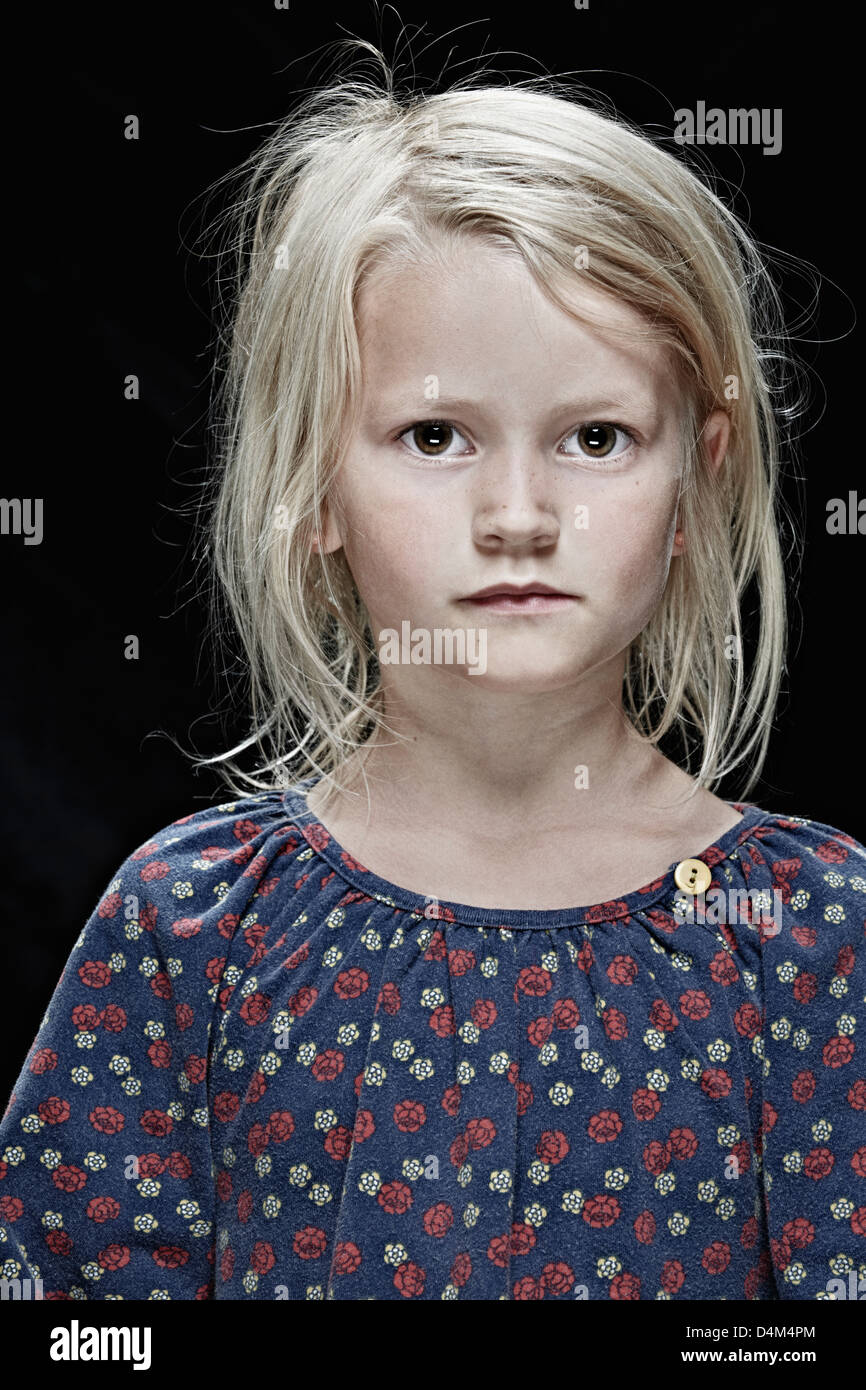 Serious girl standing indoors Stock Photo - Alamy