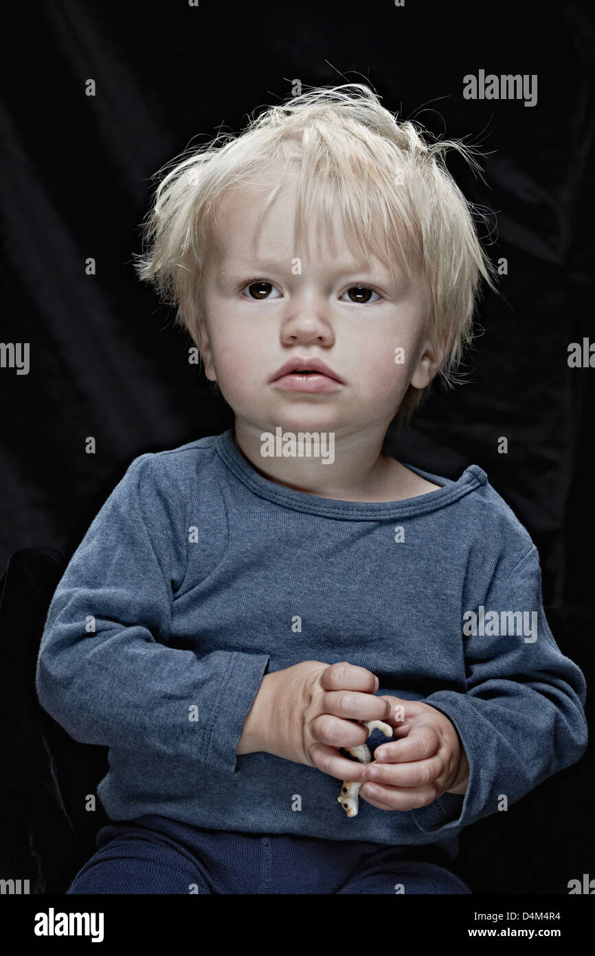Boy playing with small toy Stock Photo - Alamy