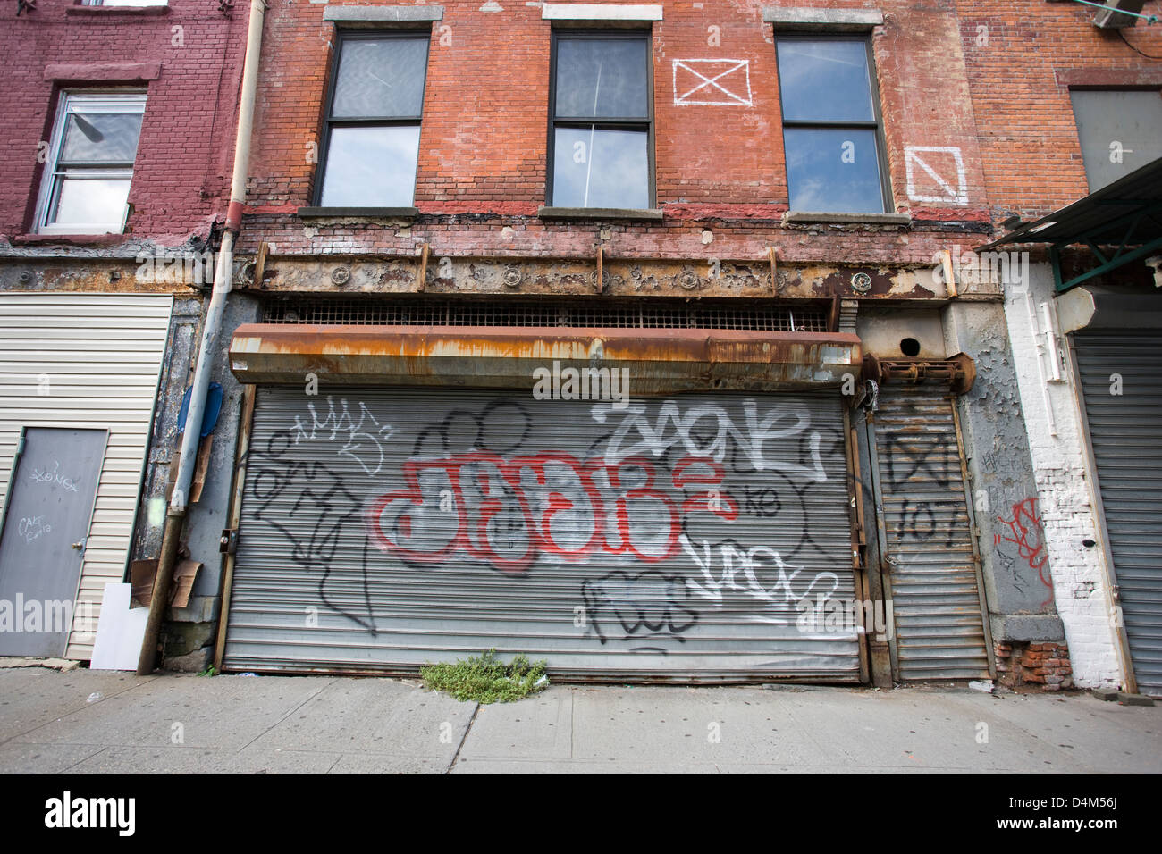 Derelict and empty shops in the street under the Brooklyn Bridge in New ...