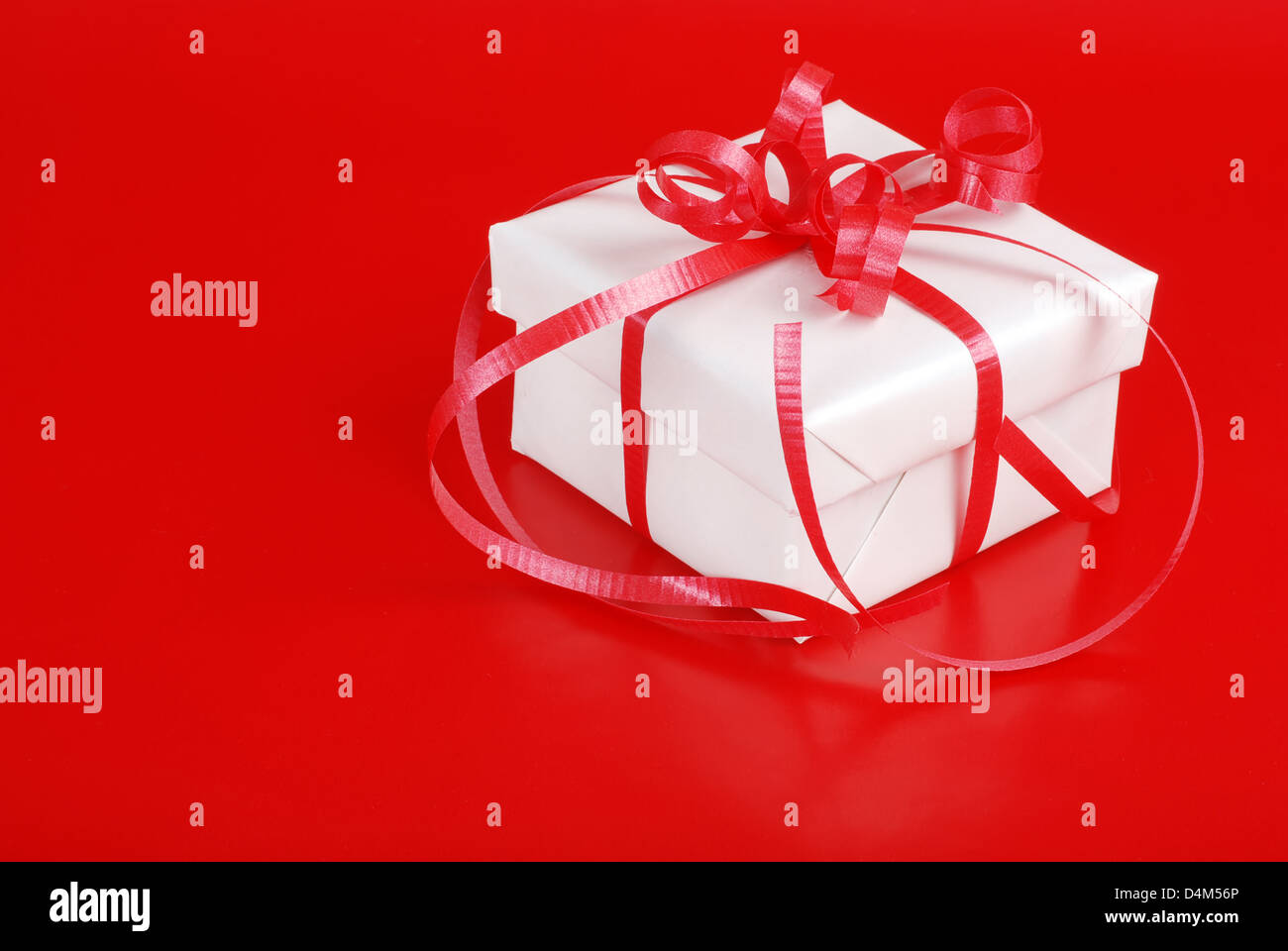 White christmas gift with red ribbon hi-res stock photography and ...
