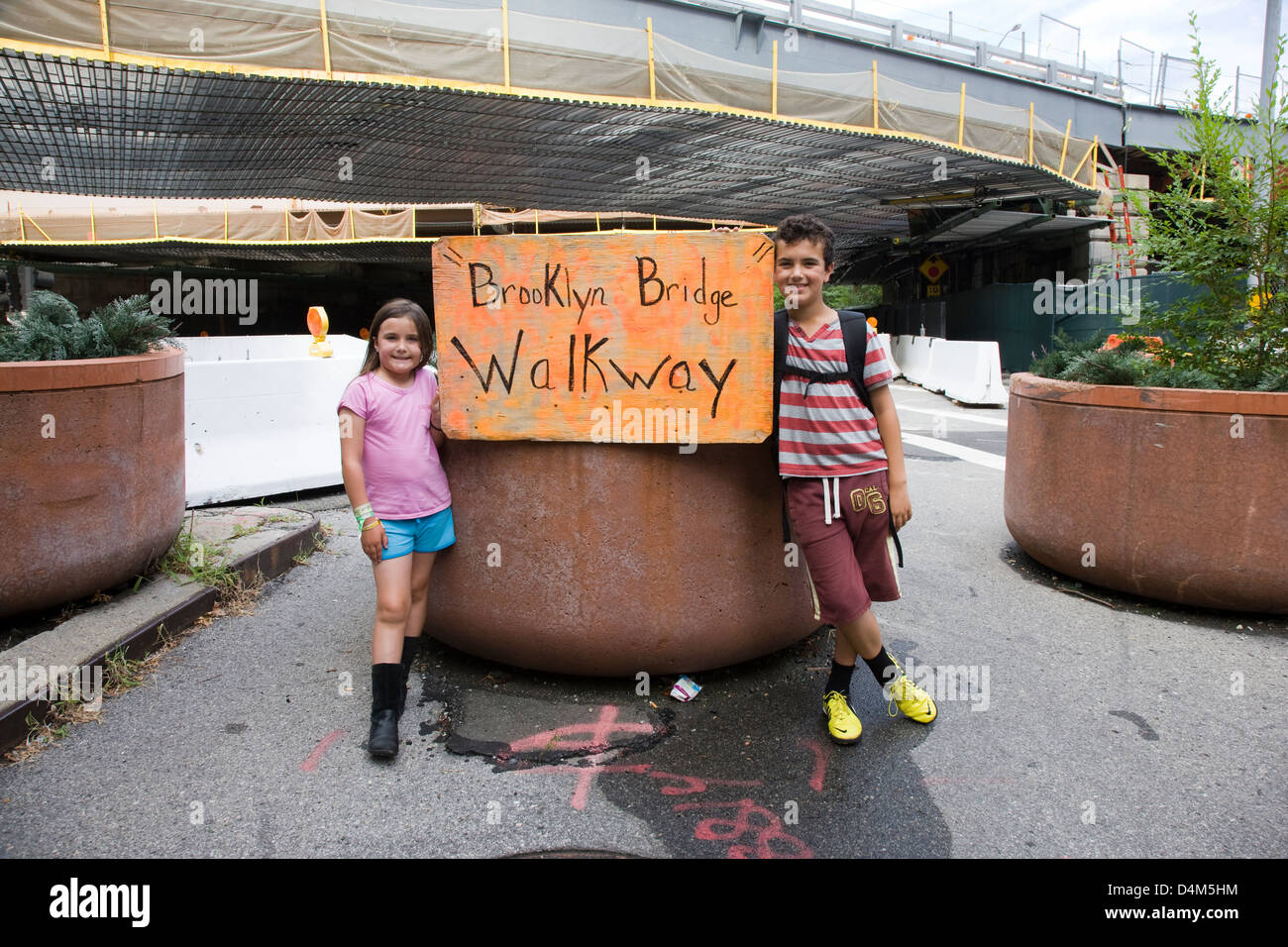 Children visitors next to a temporary, hand made, road sign "Brooklyn ...