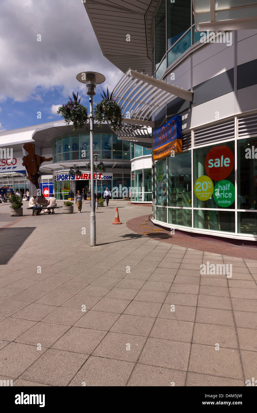 Curved shop fronts and shoppers in the Rushes Shopping Centre ...