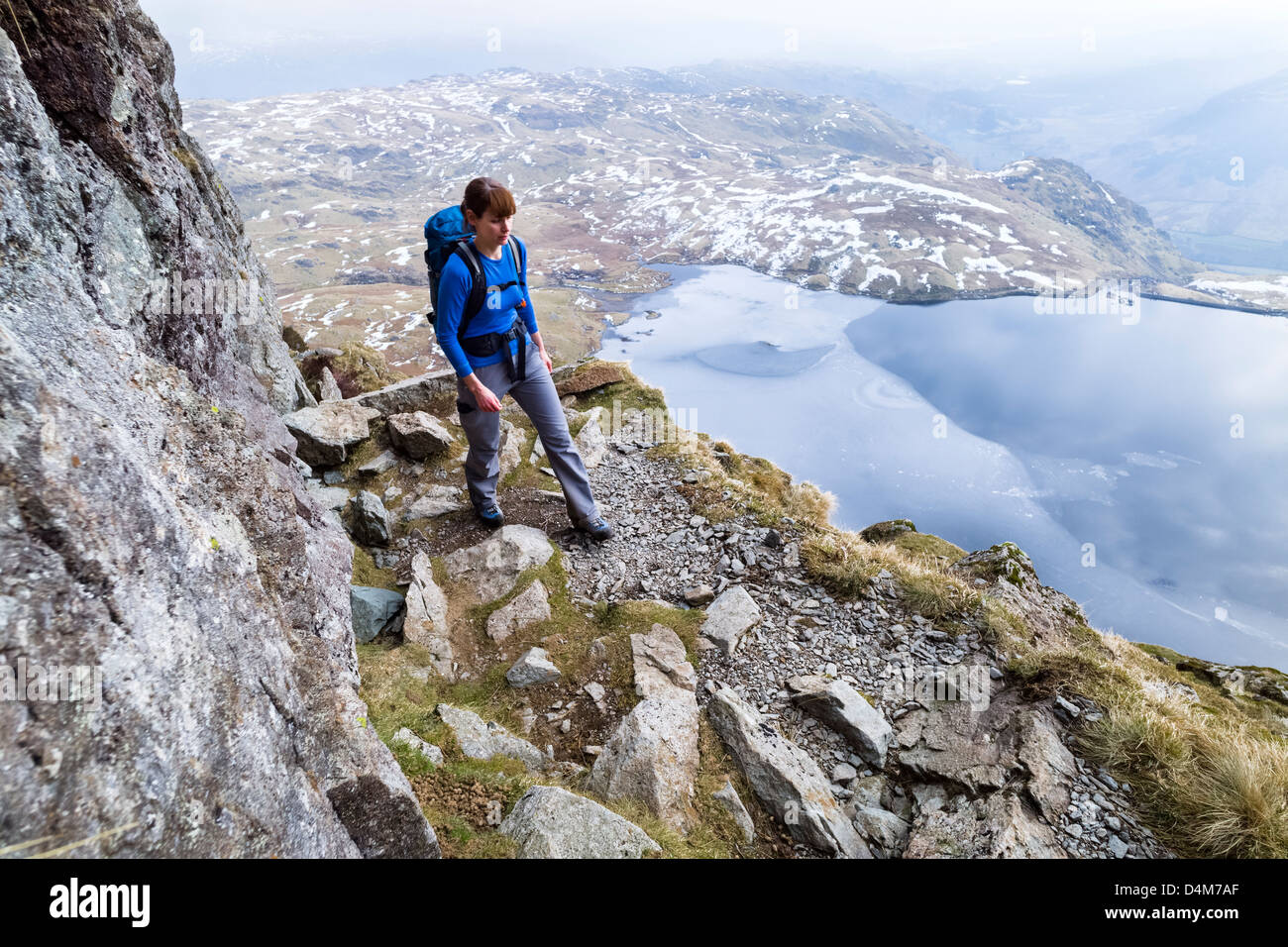 A hiker ascending Jack's Rake on Pavey Ark in the Lake District Stock ...