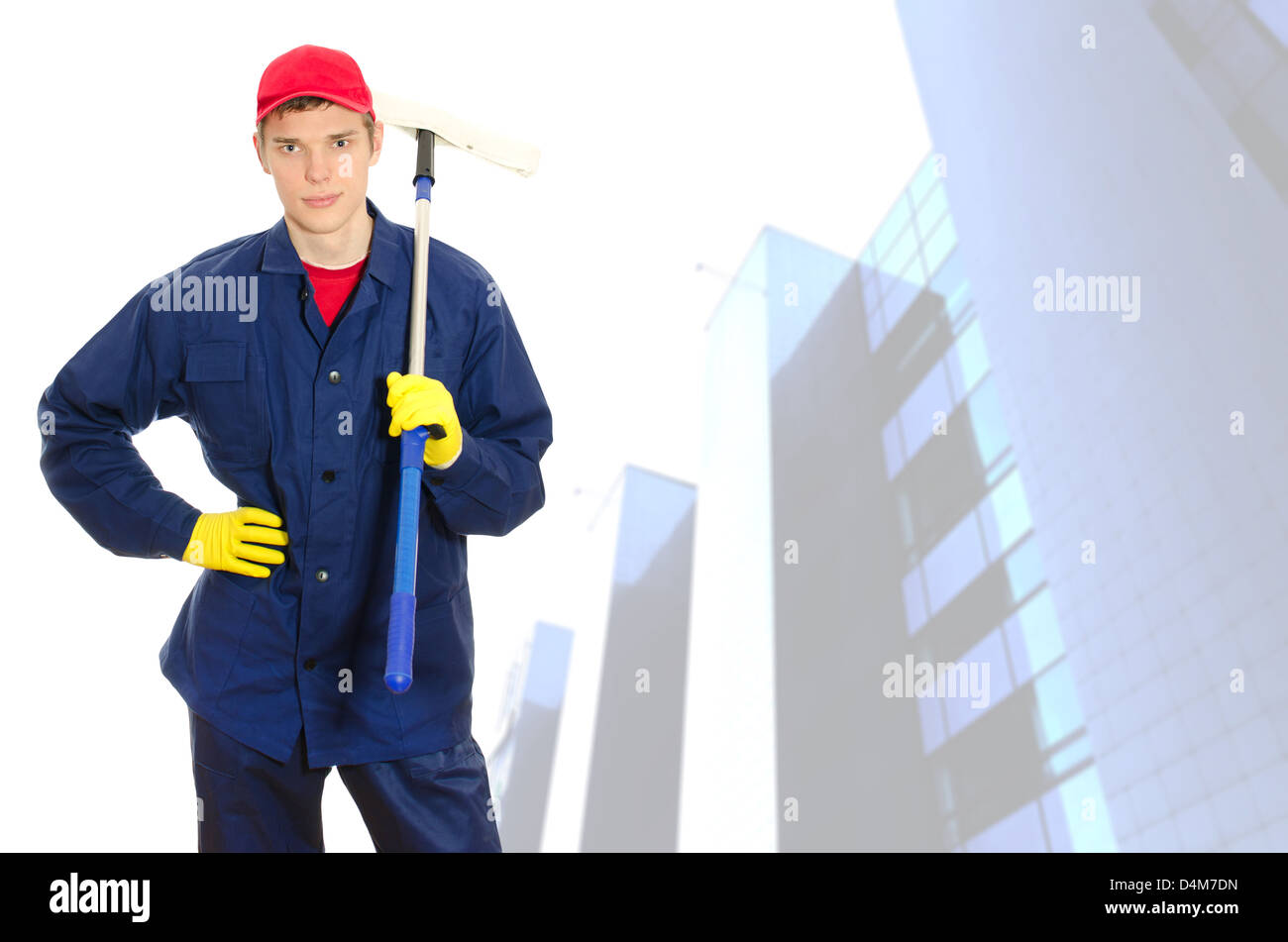 Young male window cleaner with wiper over building with glass facade ...