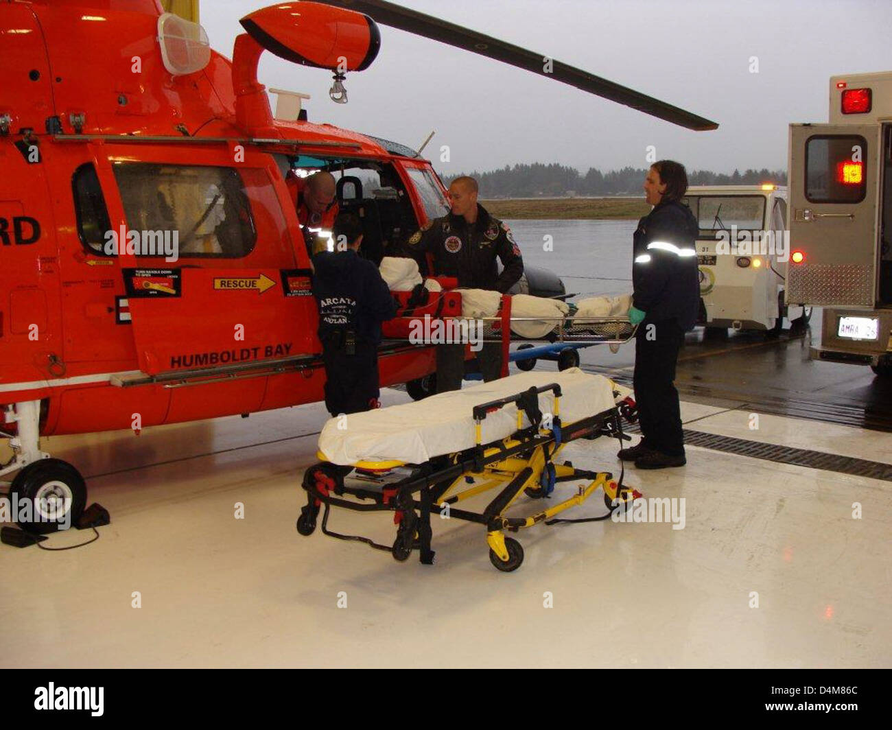The U.S. Coast Guard aircrew safely transfers an injured crewmember ...