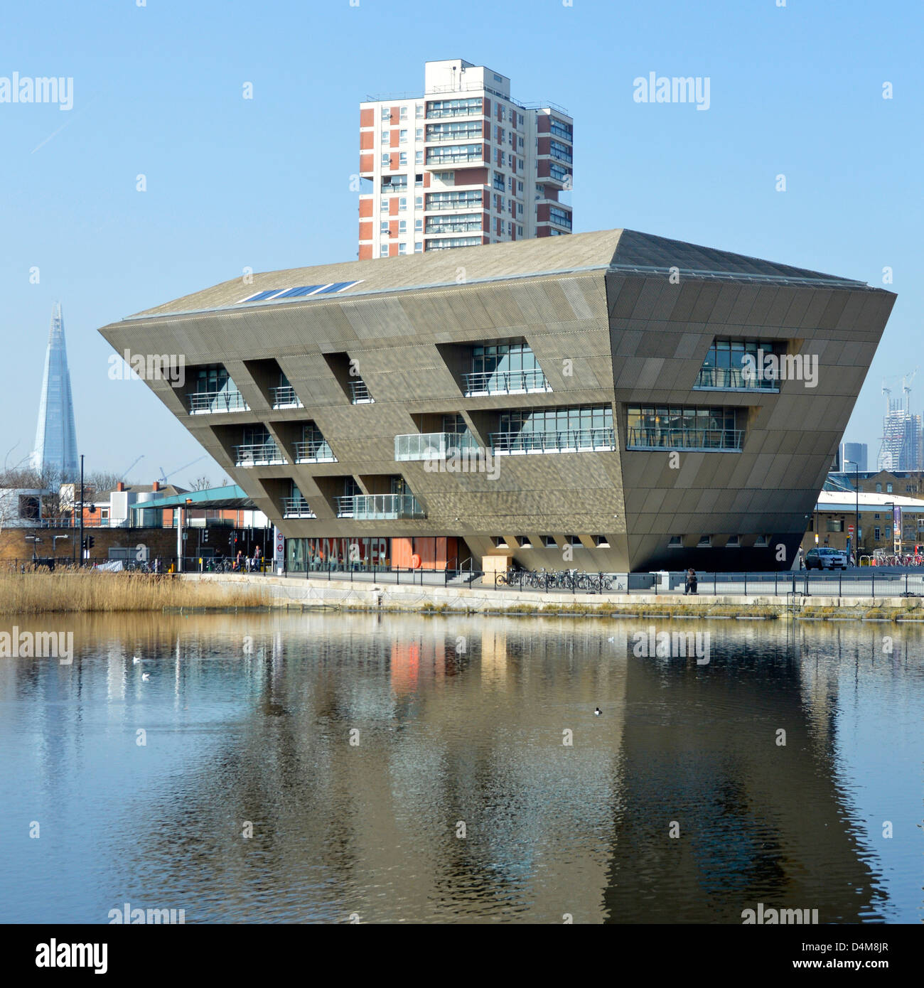 Unusual shapes of modern buildings reflected in Canada Water lake ...