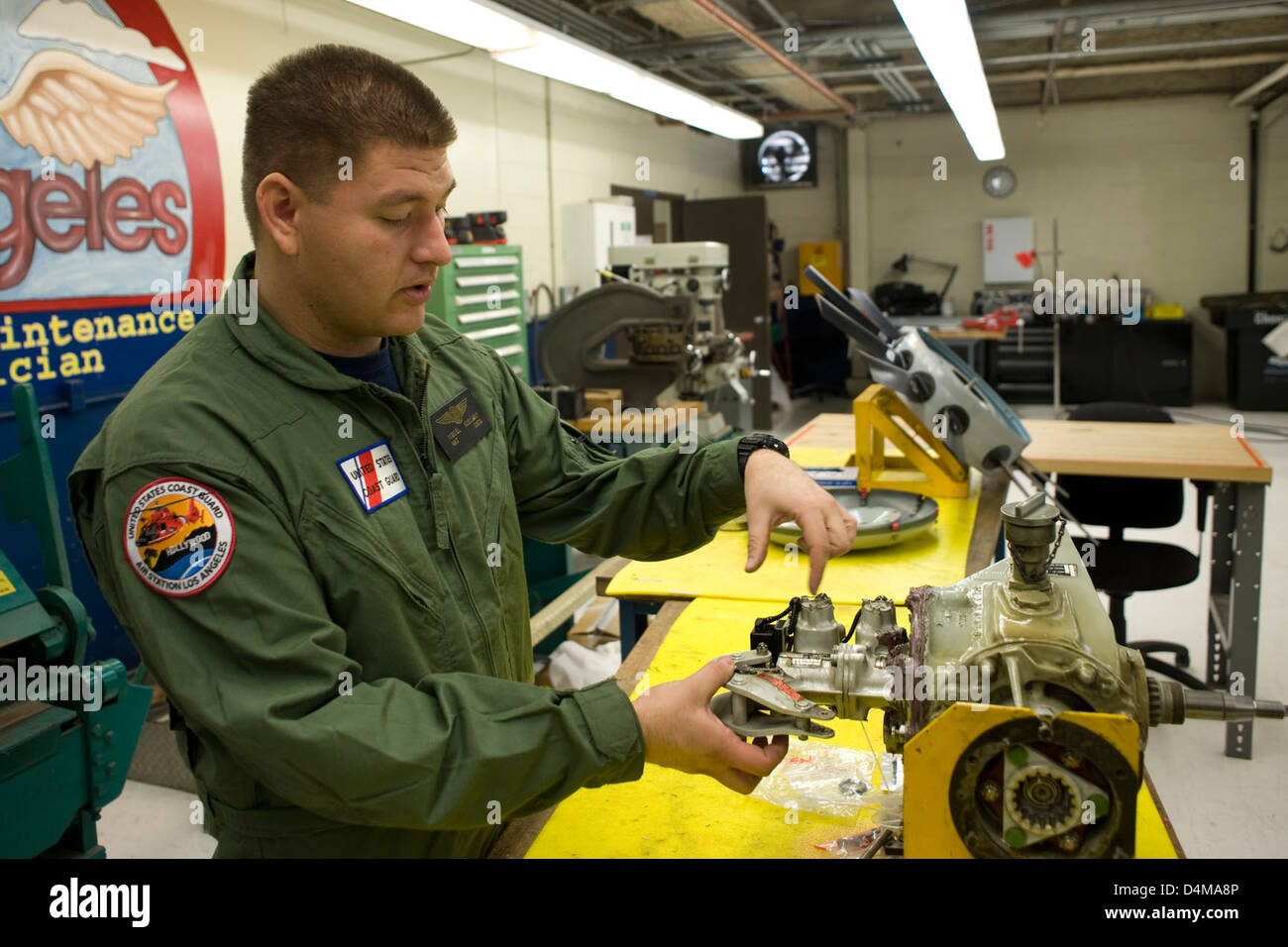 AMT2 Arellano, a Coast Guard Aviation Maintenance Technician Second Class, performs maintenance ...