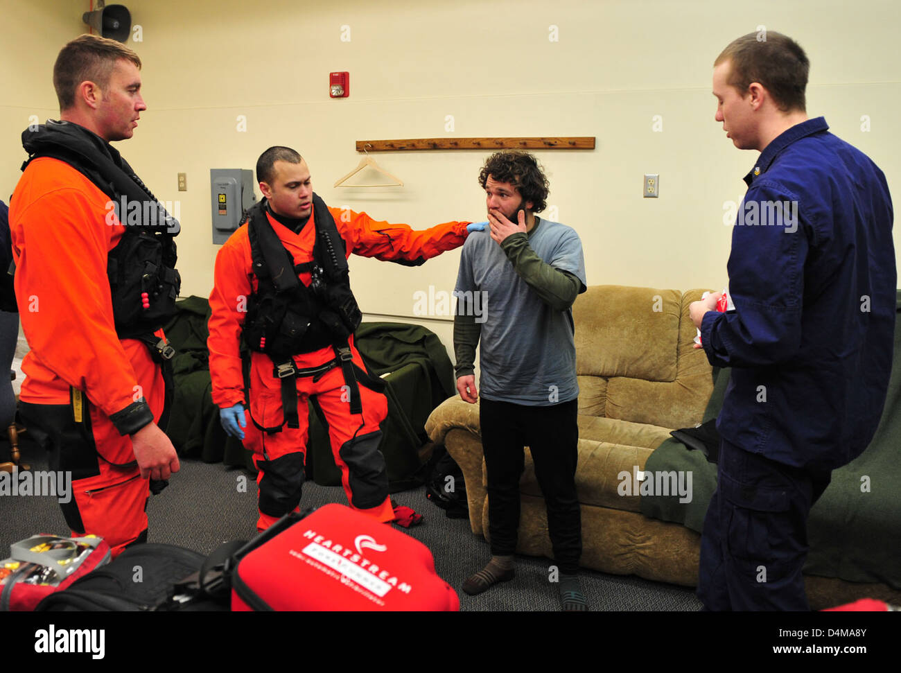 Medical corpsmen from the Coast Guard's Air Station D17 assess a ...