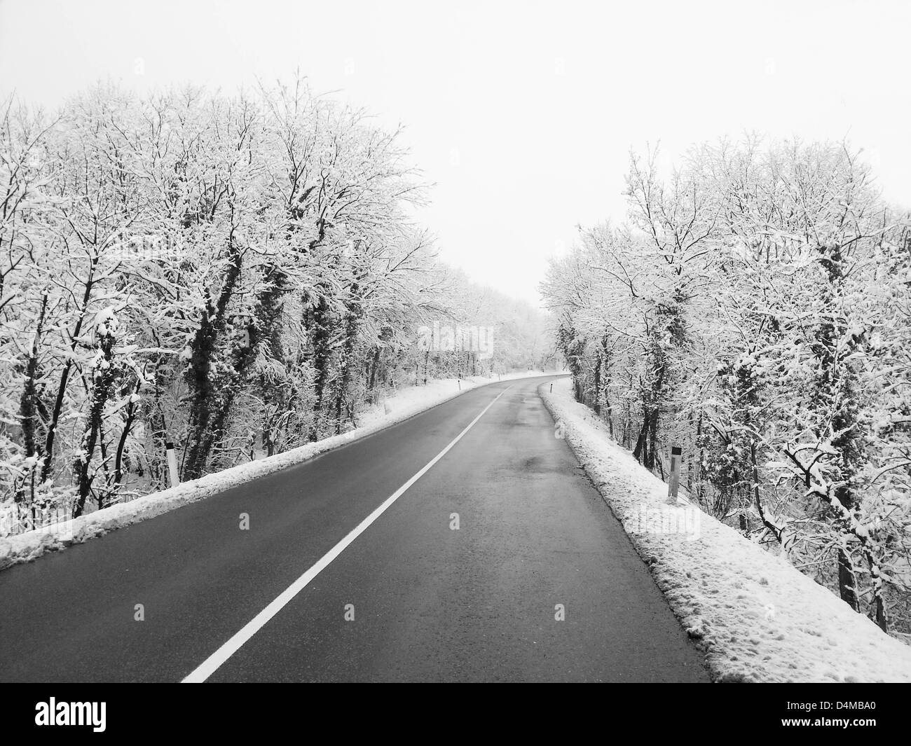 Icy road snow covered Black and White Stock Photos & Images - Alamy