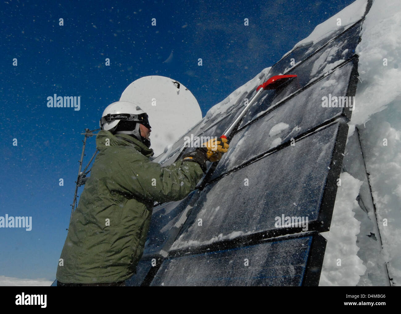 Coast Guard personnel in Kodiak, Alaska, clear VHF-FM solar panels as ...