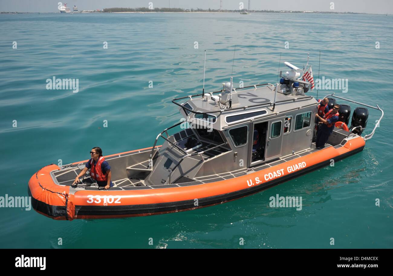 A small boat crew from the U.S. Coast Guard pulls alongside the CGC ...