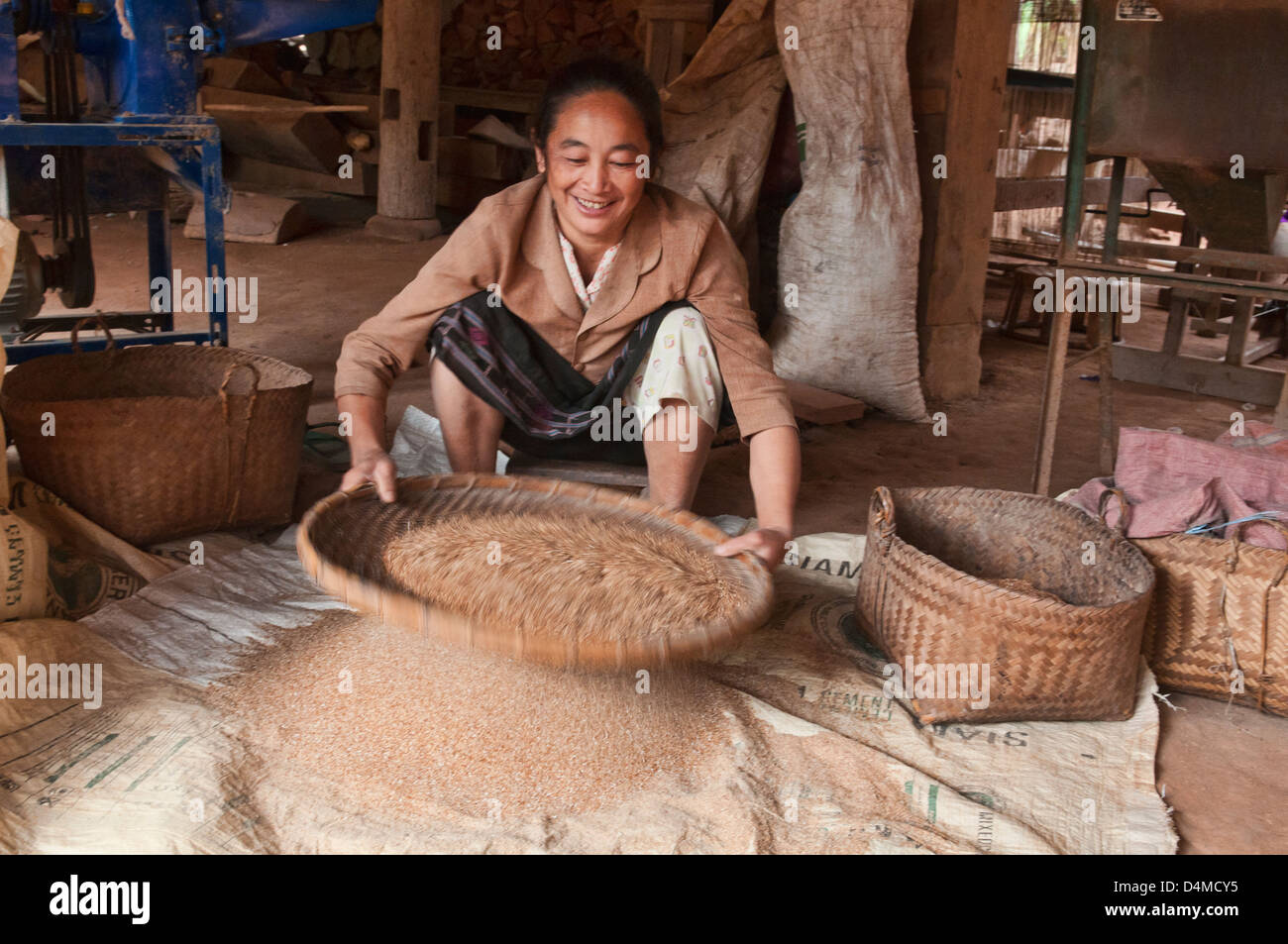 ethnic Khmu woman sifting rice, Luang Nam Tha, Laos Stock Photo - Alamy