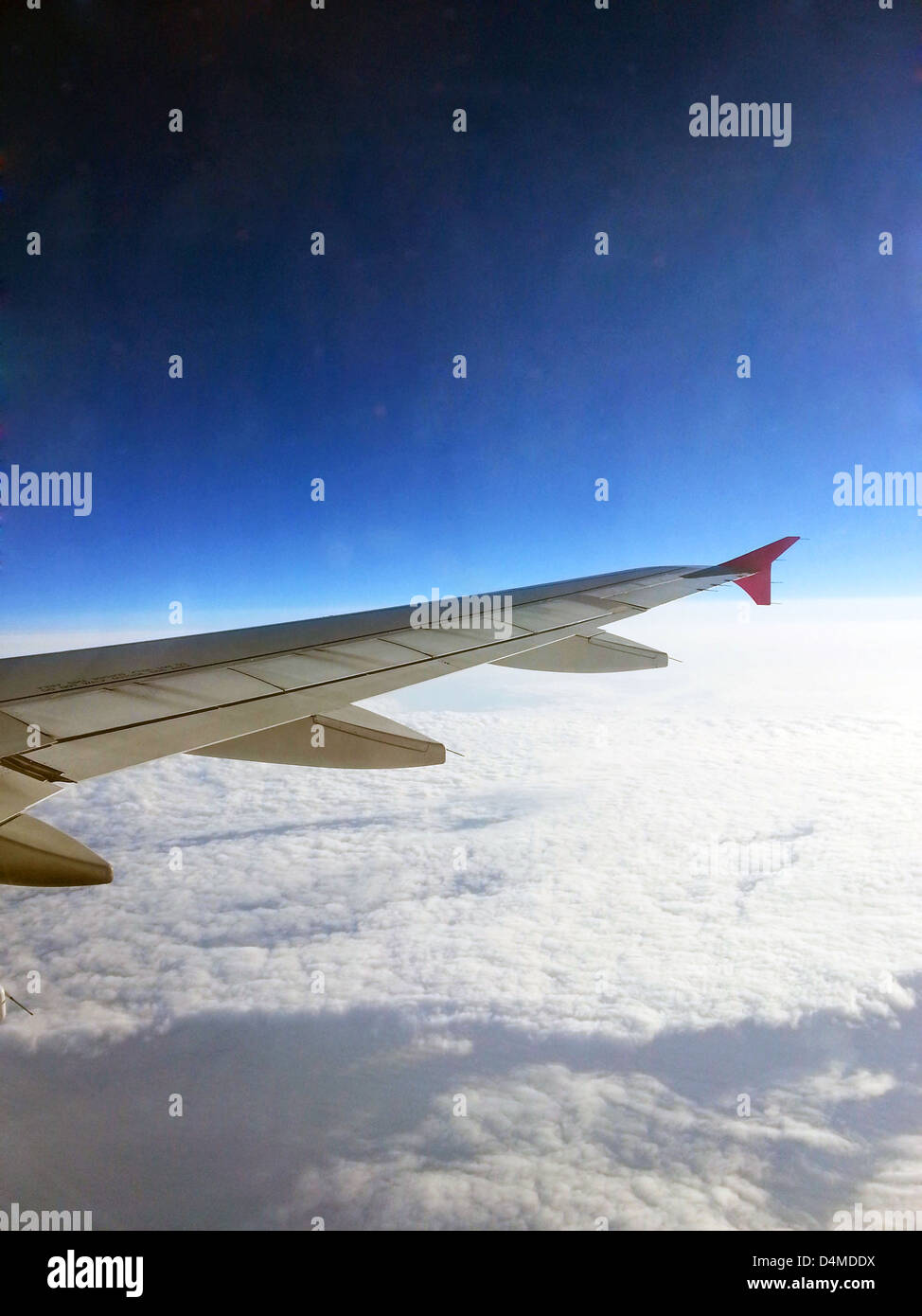 Wing of airplane through window Stock Photo - Alamy