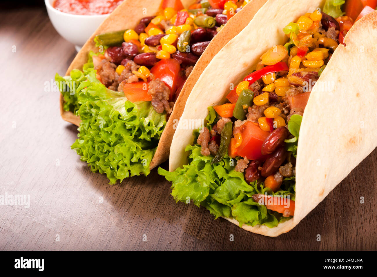Pair of tacos on the wooden table Stock Photo - Alamy
