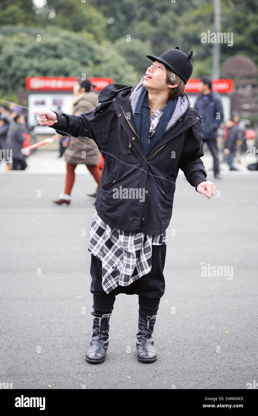 Stylish Chinese youth flying a kite in Wushan Square, Hangzhou Stock ...
