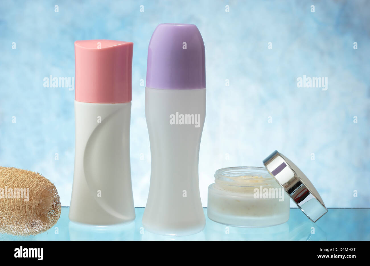 a group of deodorants with cream on blue sky background Stock Photo - Alamy
