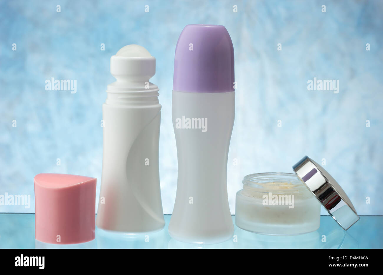 a group of deodorants with cream on blue sky background Stock Photo - Alamy