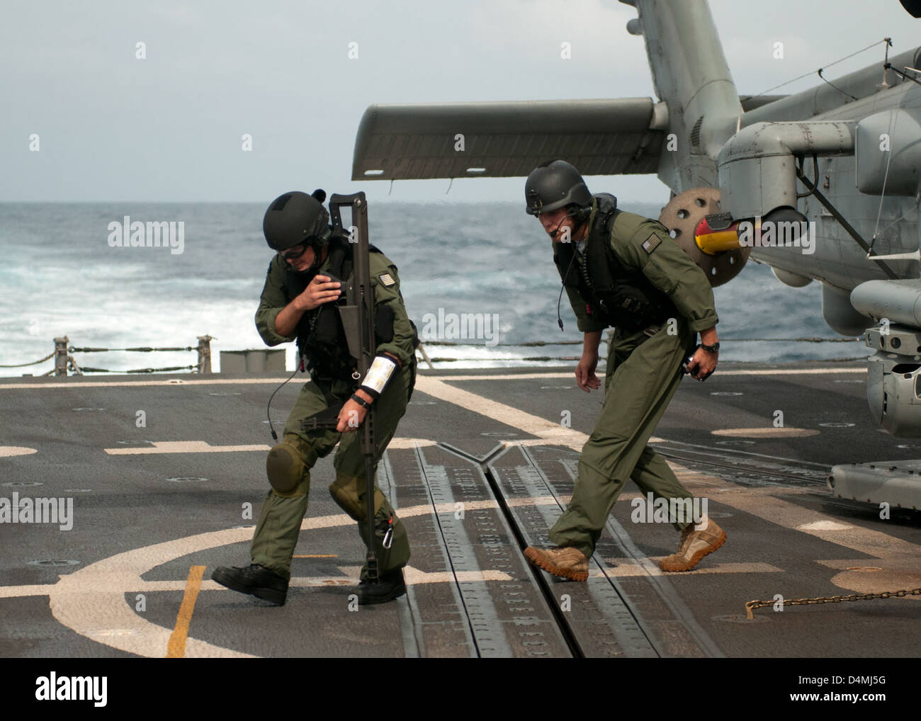 This image captures the Coast Guard's armed forces on the flight deck ...