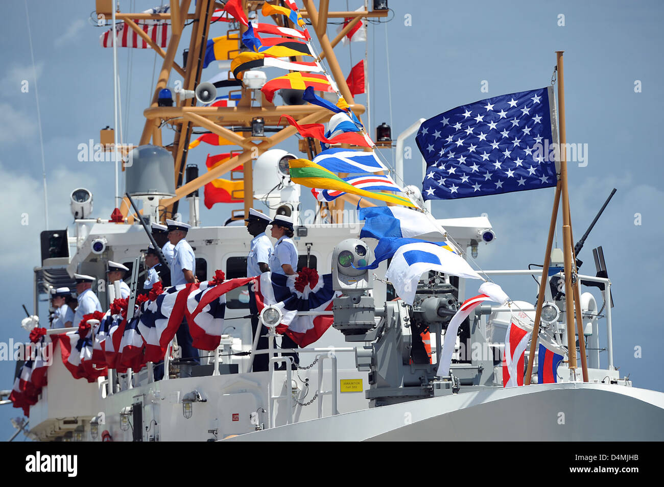 Coast Guard personnel man the rails during a ceremonial event ...