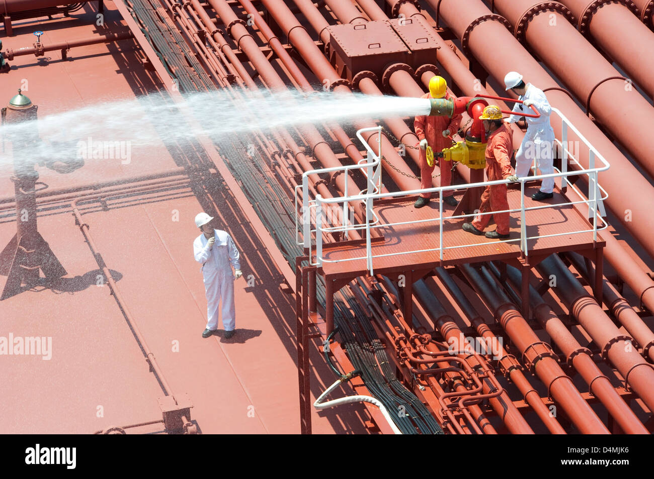 A Coast Guard vessel is equipped with a firefighting monitor to enhance ...
