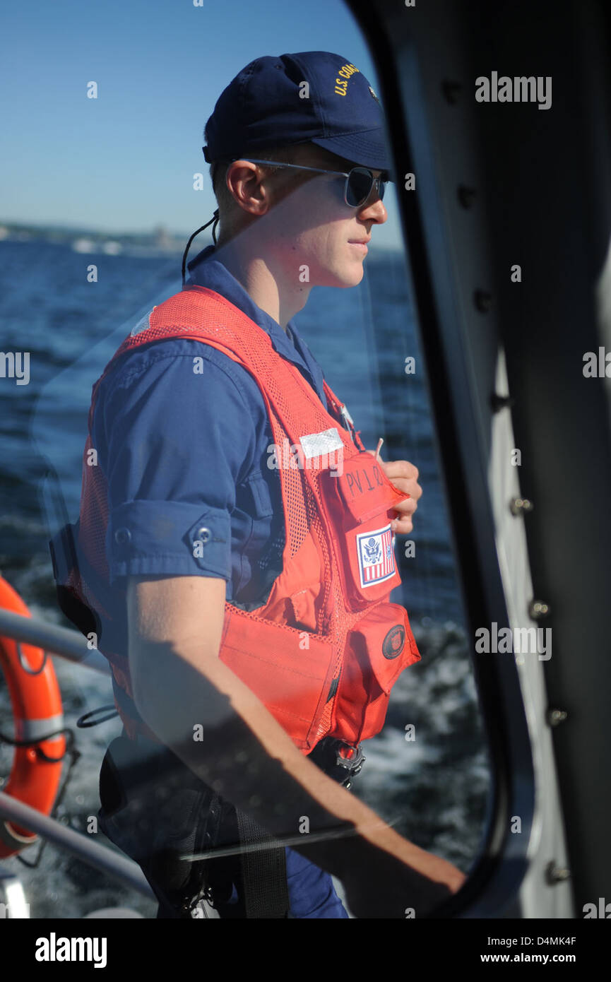 Petty Officer 2nd Class Dan Backman operates a 45-foot Response Boat ...