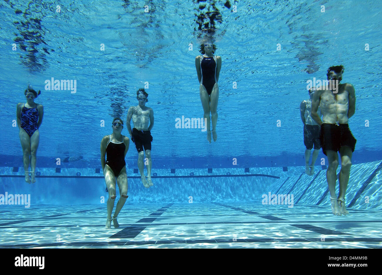 US Olympic Team triathletes perform down proofing exercises during a ...