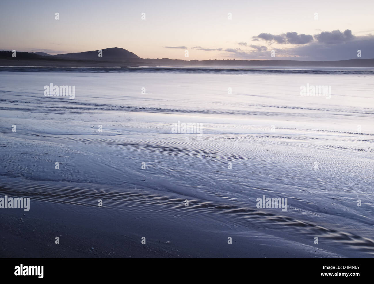 Sunset on the beach with sand and blue color Stock Photo - Alamy