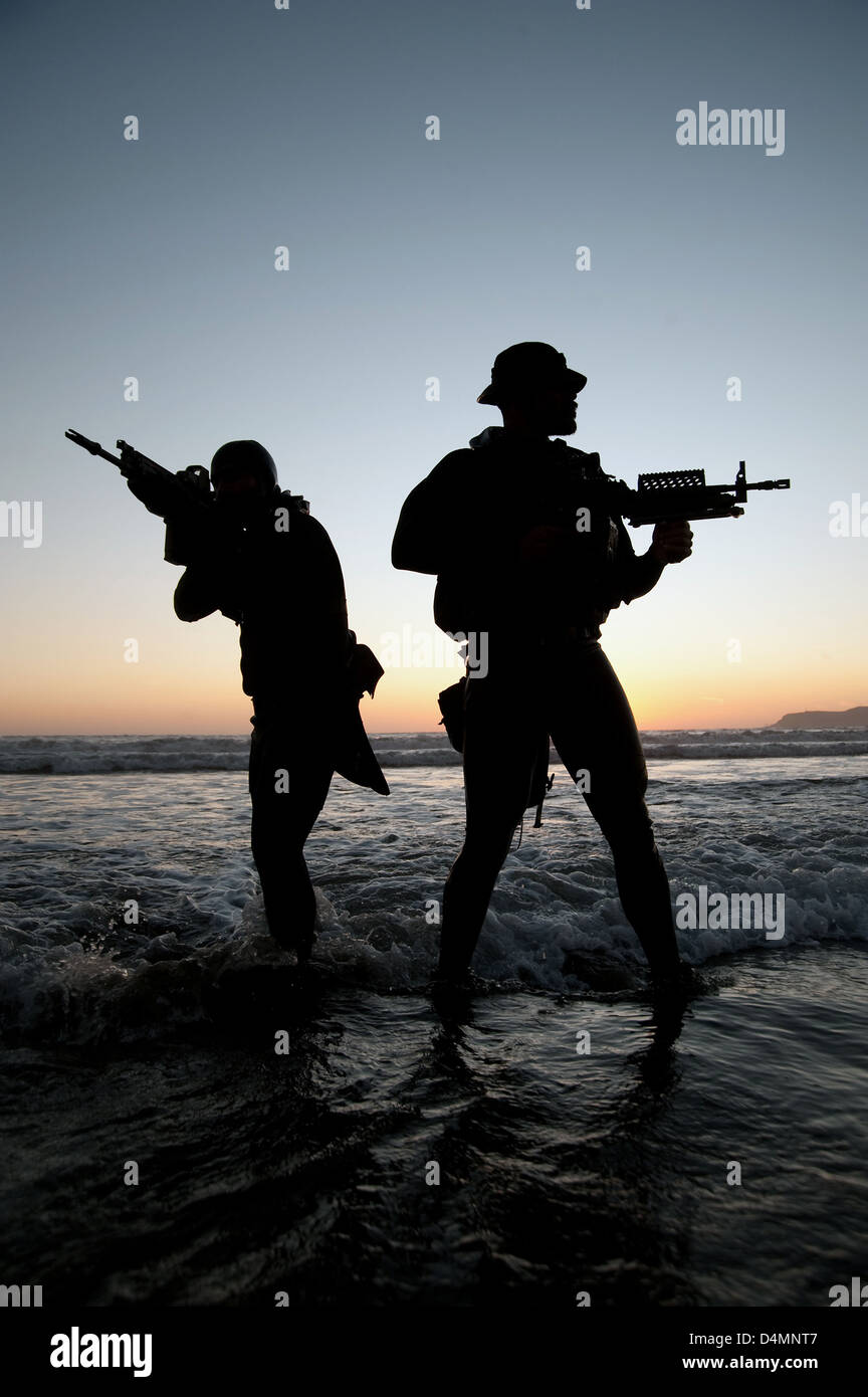 Members of the US Navy SEALs practice water insertion at sunset at the ...