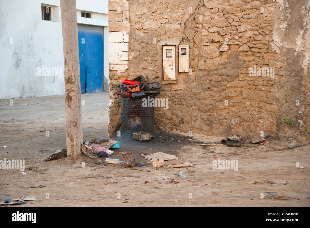 Oil containers strewn around an old oil drum Stock Photo - Alamy