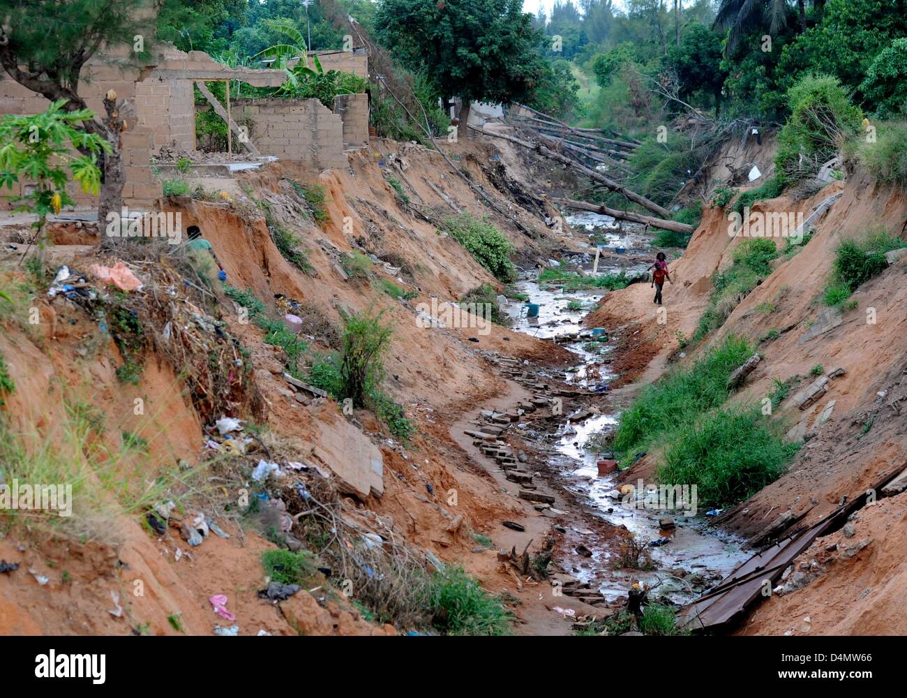 Destroyed houses stand in Bairro de Laulane near Maputo in Mozambique ...