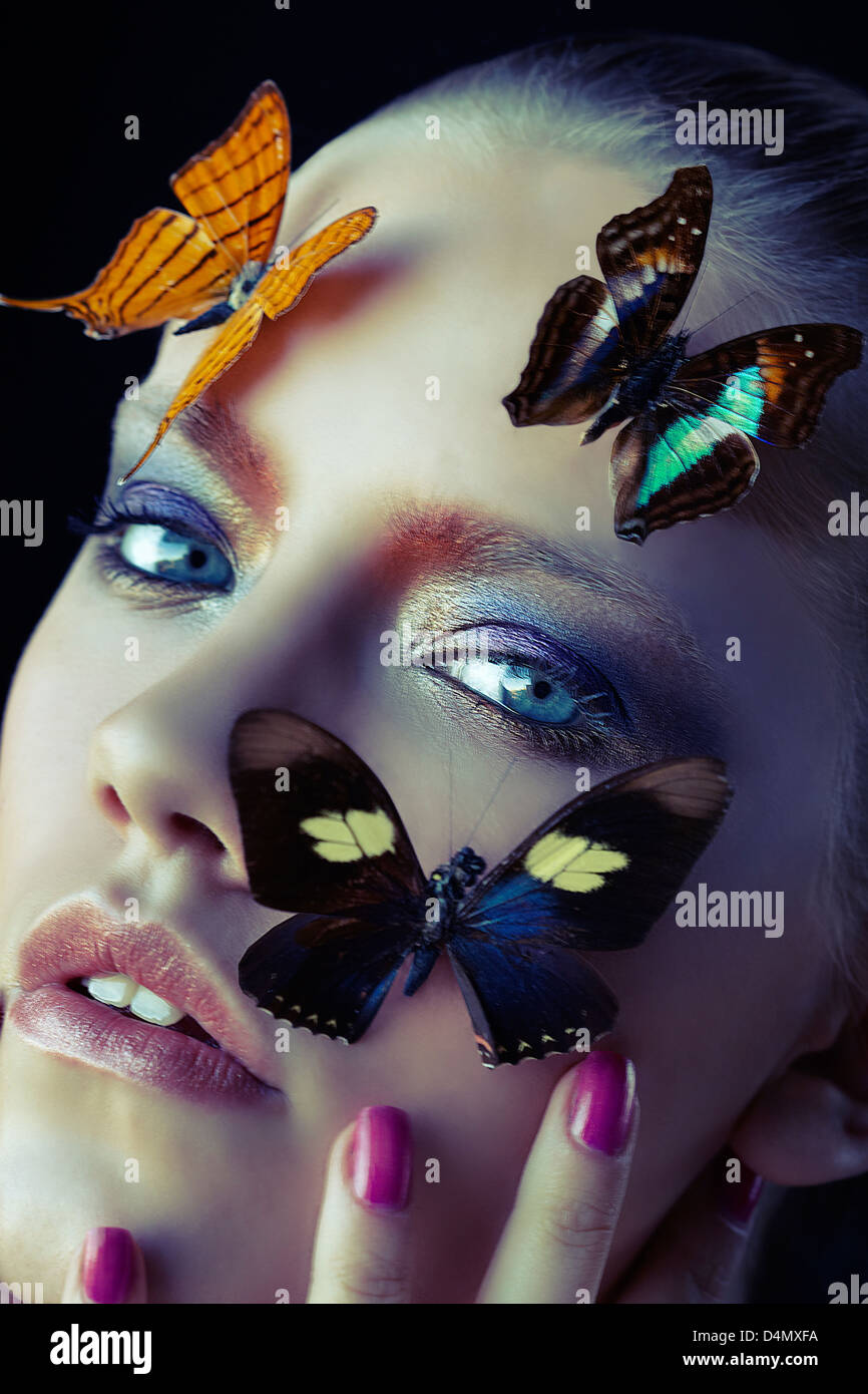 A young white woman with real butterflies on her face Stock Photo - Alamy