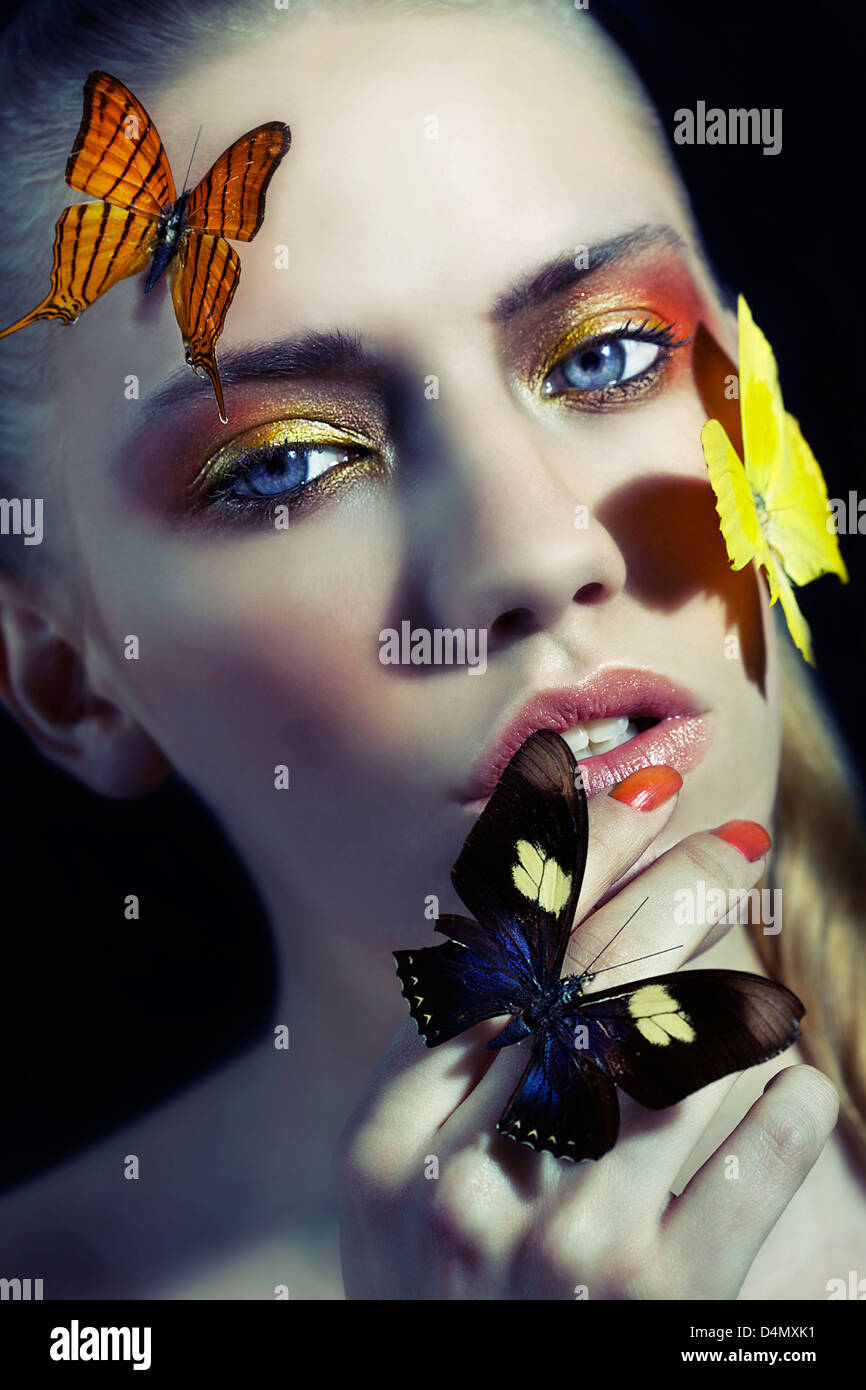 A young white woman with real butterflies on her face Stock Photo - Alamy